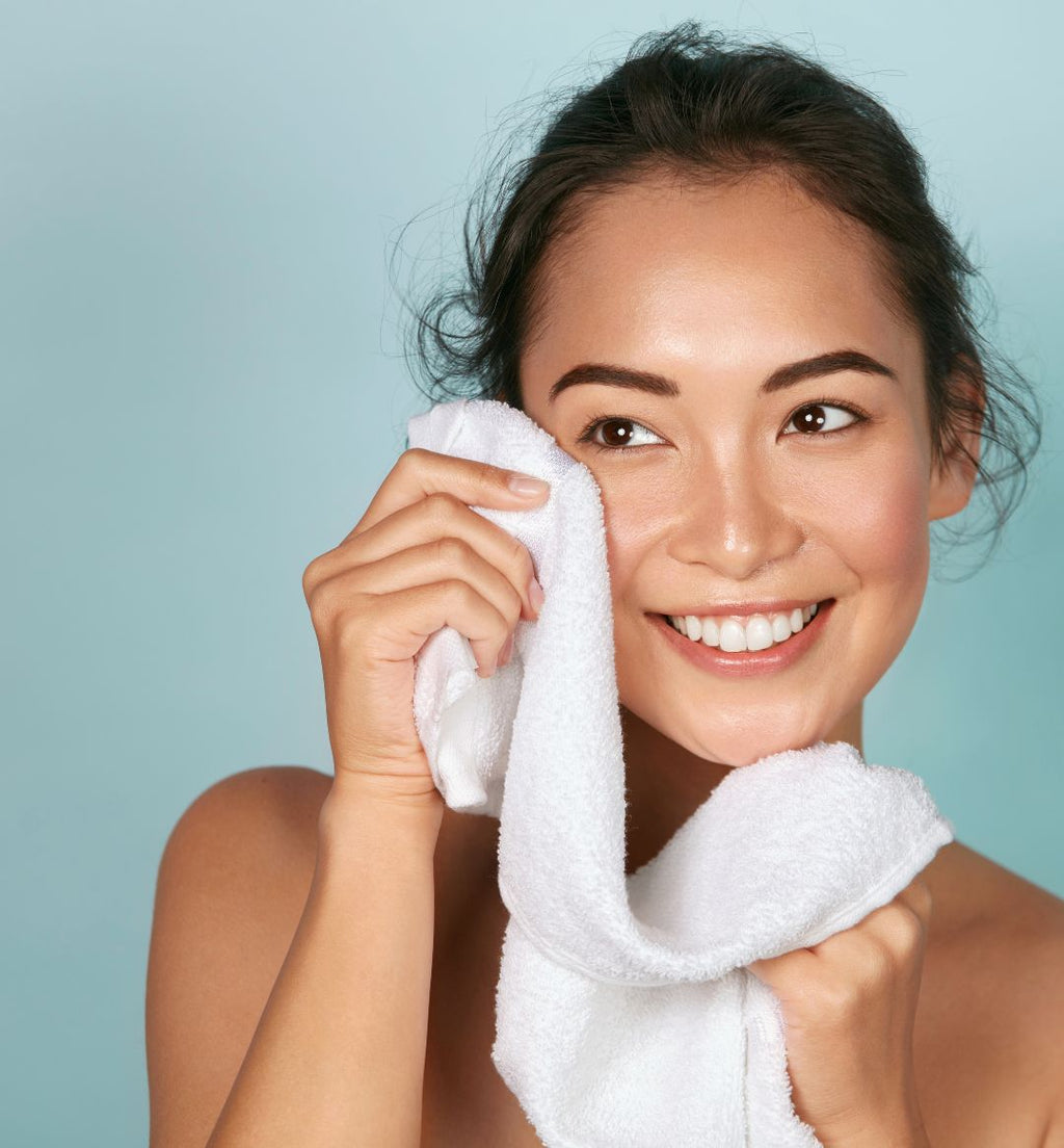 drying face with microfiber towel